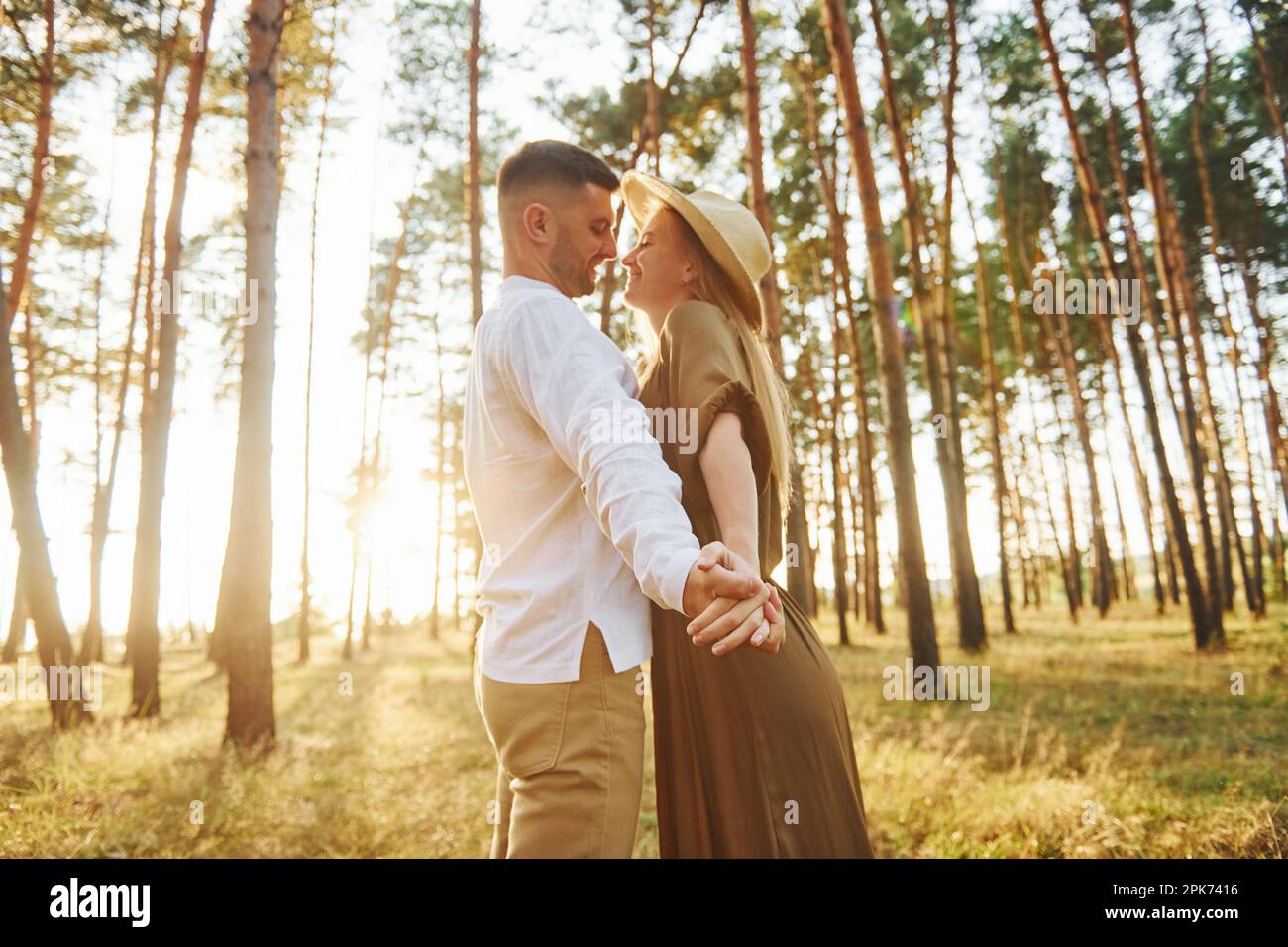Warm weather. Happy couple is outdoors in the forest at daytime Stock ...