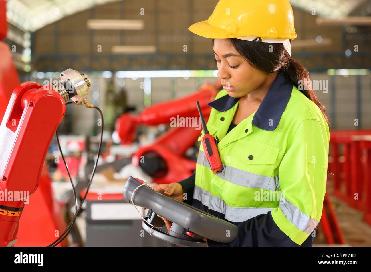 Professional female mechanical engineer in yellow hard hat and safety uniform Stock Photo - Alamy