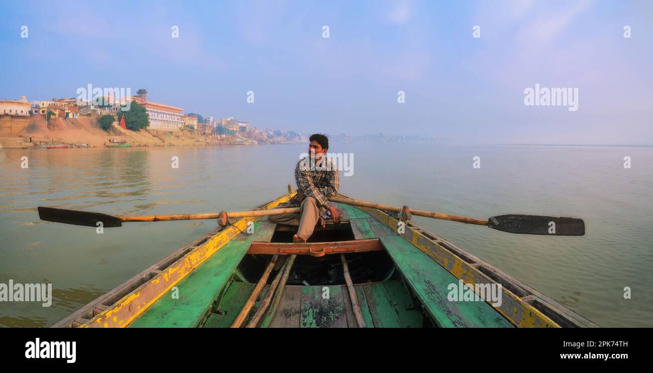 Boatman rowing on the River Ganges, Varanasi, Uttar Pradesh, India ...