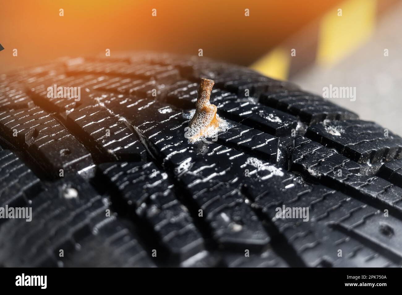 Nail sticks out of car's tire. Car wheel puncture. Close-up Stock Photo ...