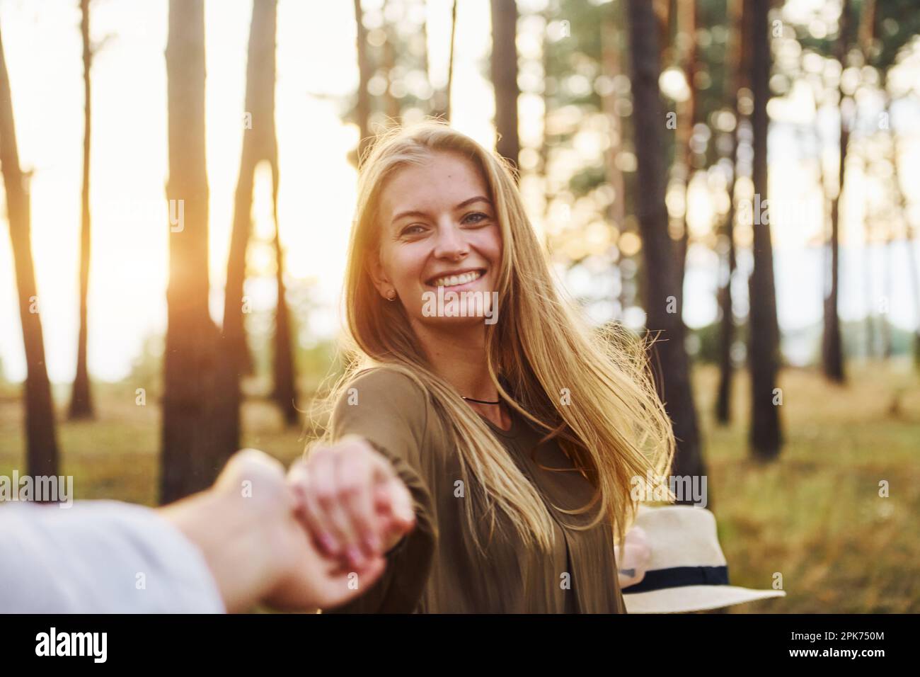 Happy couple is outdoors in the forest at daytime Stock Photo - Alamy