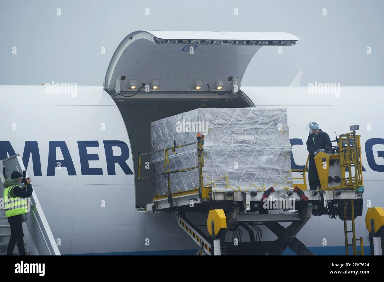 Workers load cargo onto a Boeing 767-300 cargo plane owned by the ...