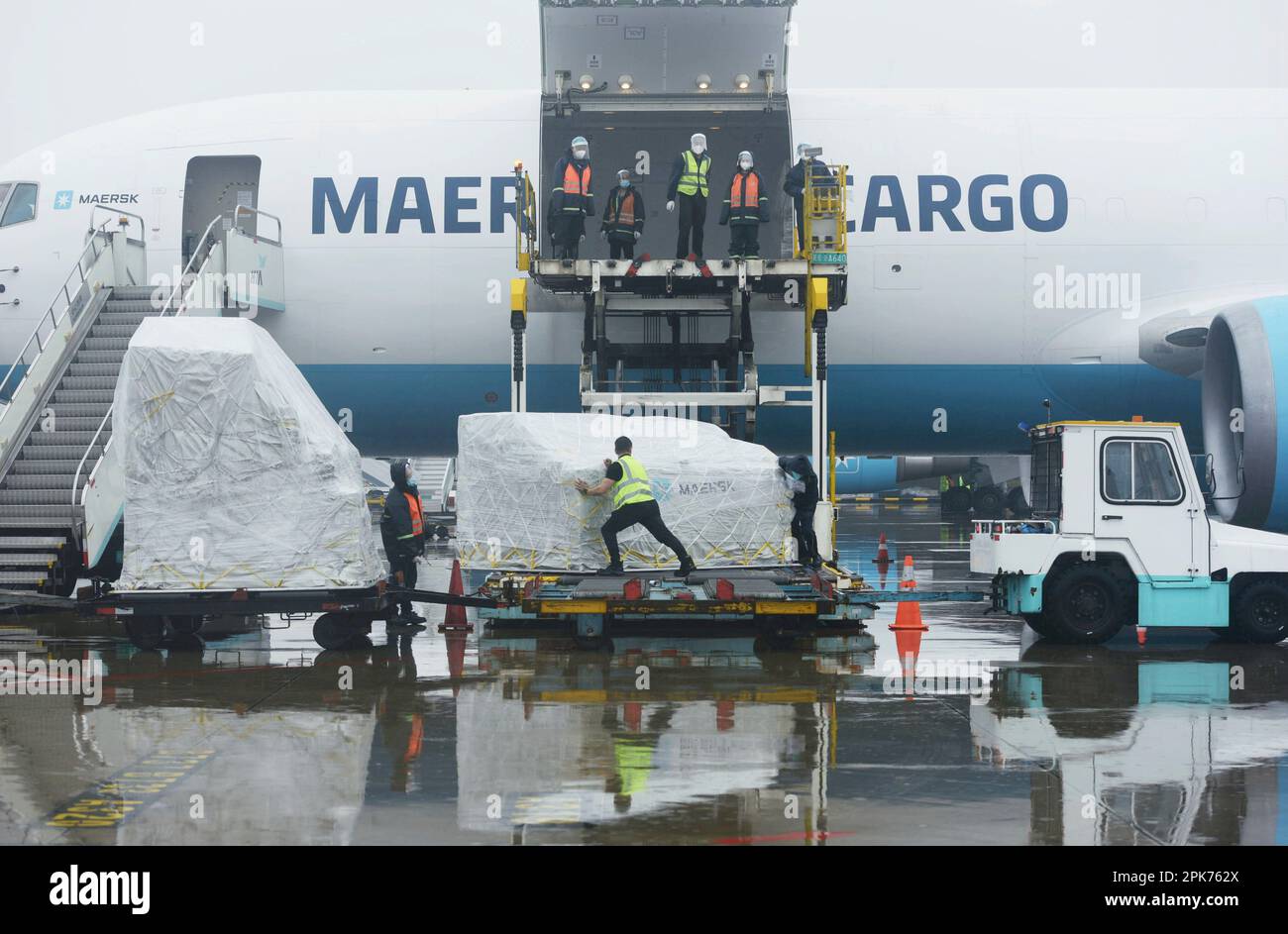 Workers load cargo onto a Boeing 767-300 cargo plane owned by the ...