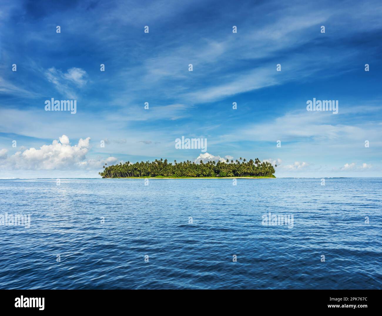Small tropical island in the middle of a calm blue sea Stock Photo - Alamy