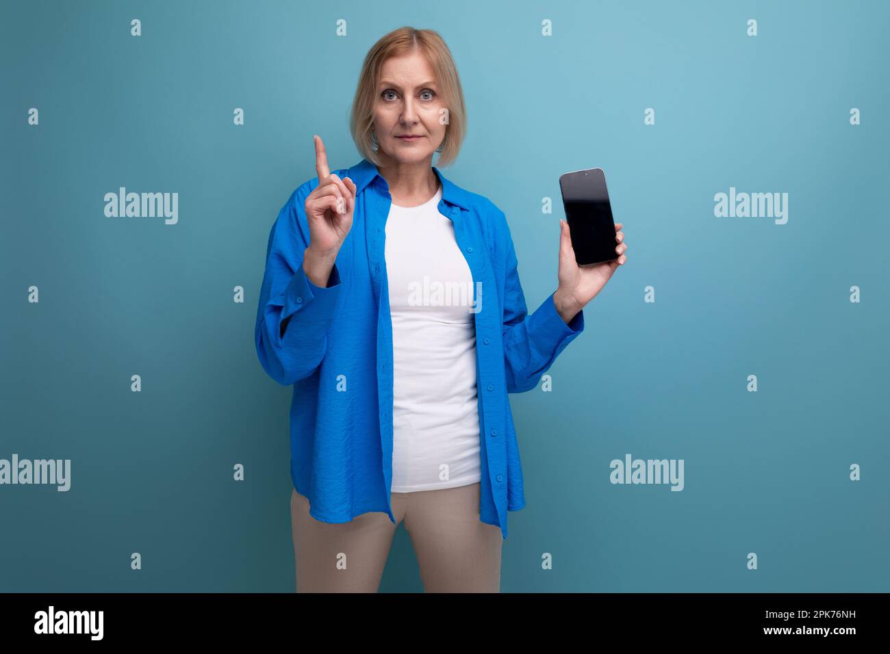 blond middle-aged woman with bob haircut holding smartphone with mocap ...
