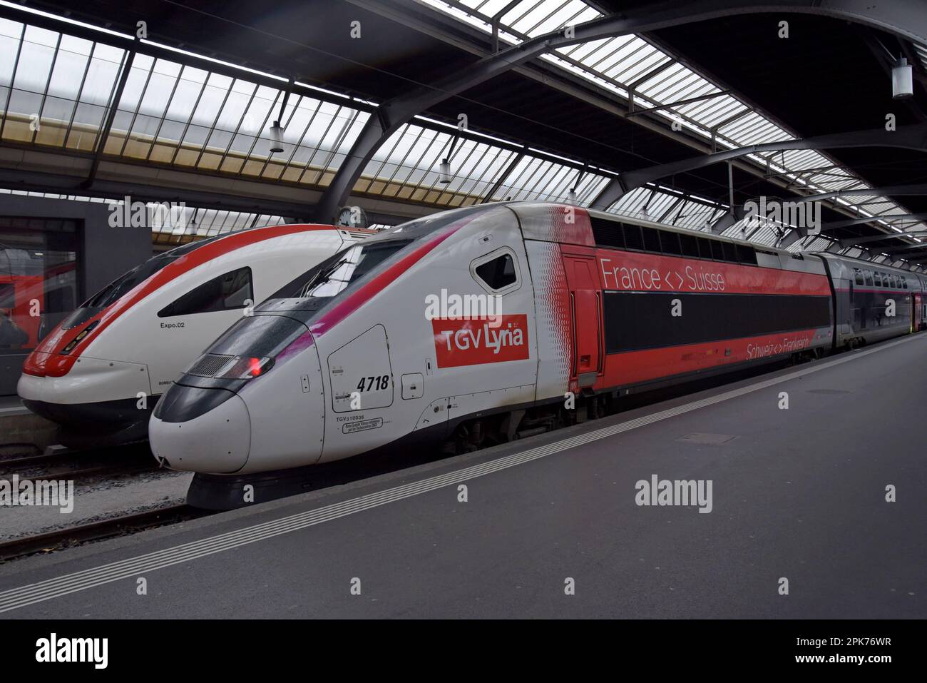 a SNCF French TGV High Speed Train next to a SBB Swiss railways train ...