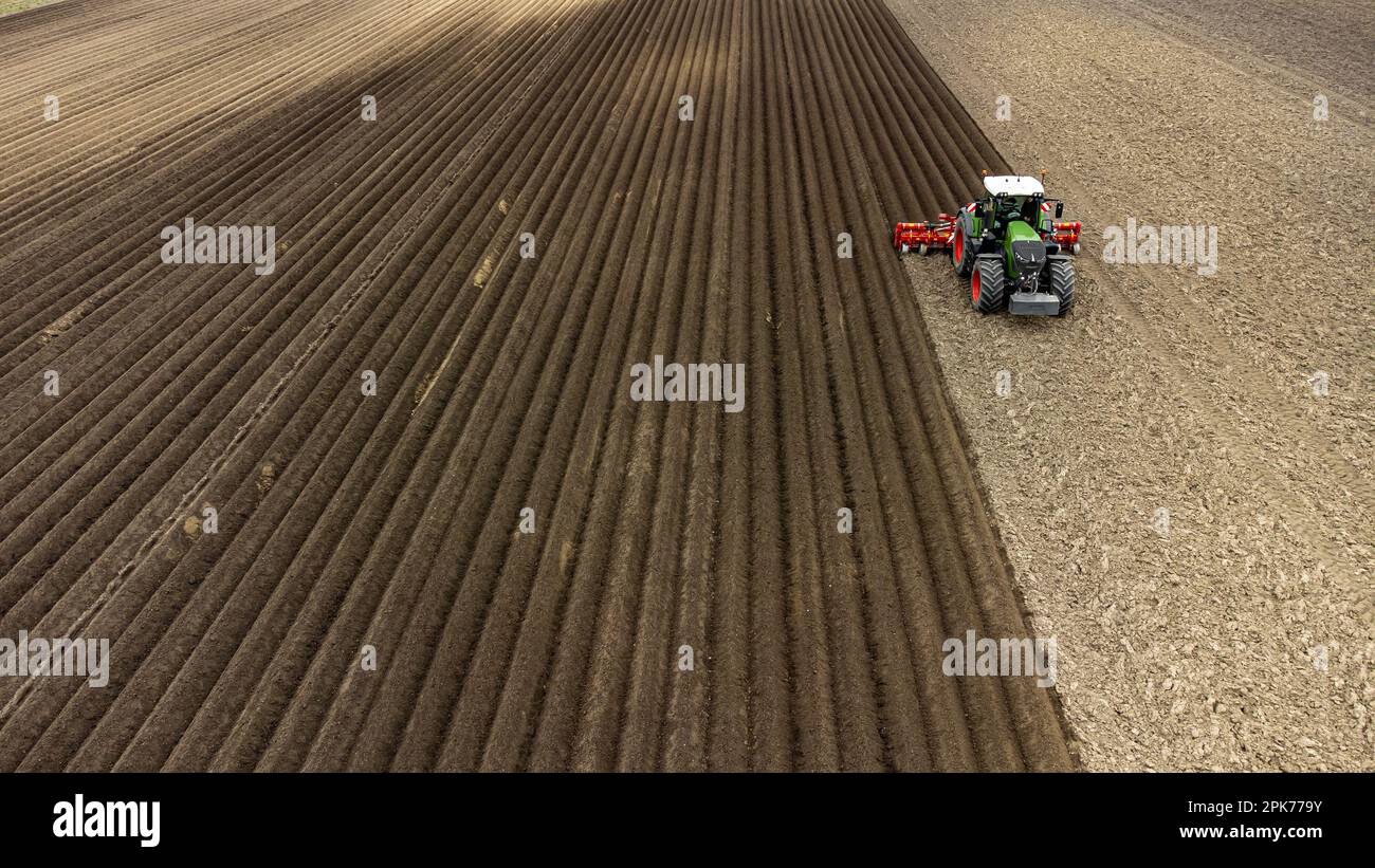 Aerial photo taken on April 4, 2023 shows tractor during soil preparation for planting potatoes ...