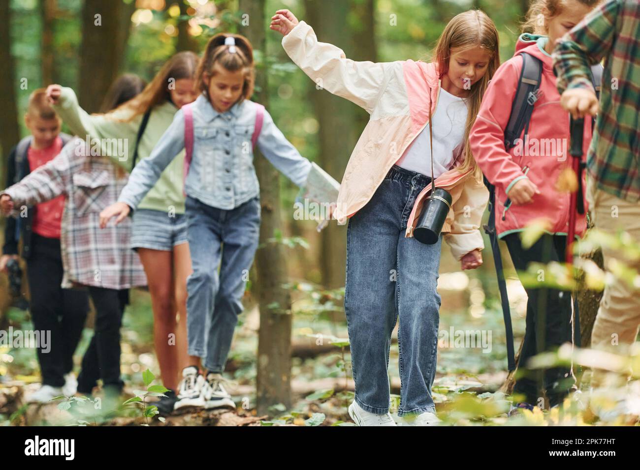 Walking on the new path. Kids in green forest at summer daytime ...