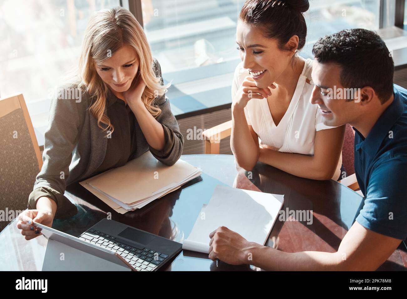 Lets go over the details. a young couple meeting with a financial ...