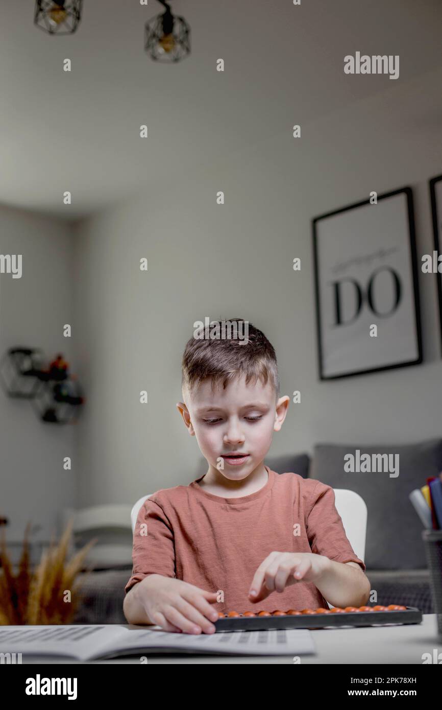 Little boy Counting with help an abacus. Mental arithmetic, brain ...