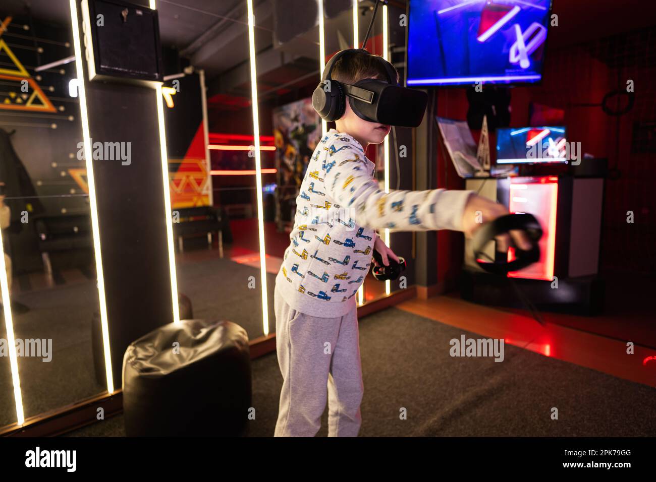 Boy kid playing game using virtual reality headset and gamepads in ...