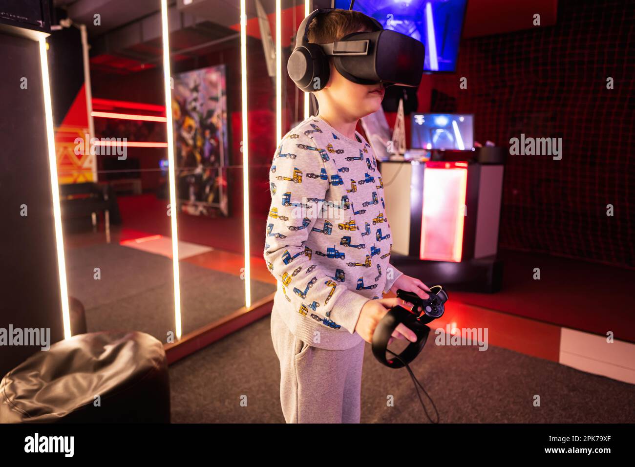 Boy kid playing game using virtual reality headset and gamepads in ...