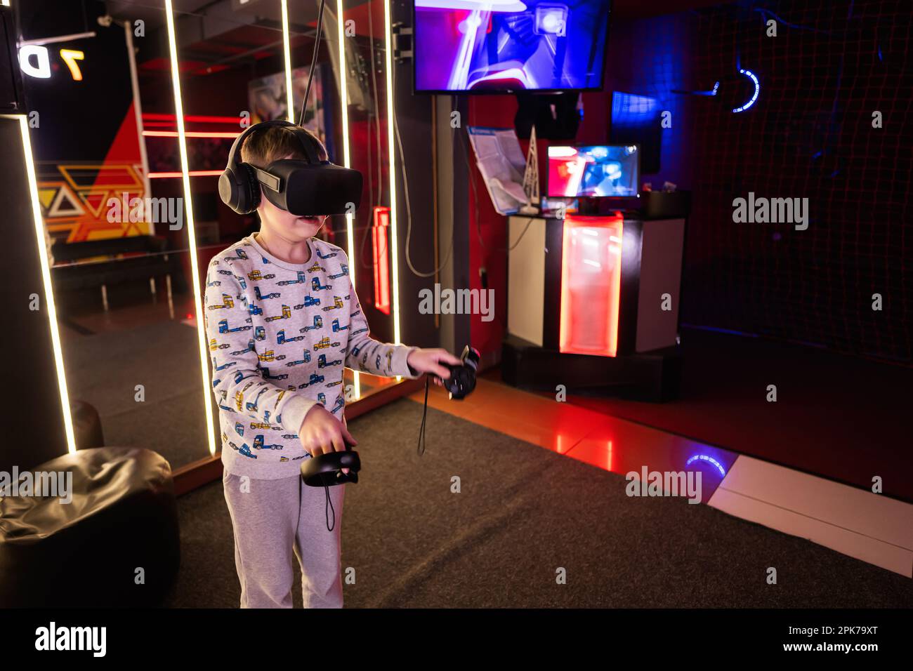 Boy kid playing game using virtual reality headset and gamepads in ...