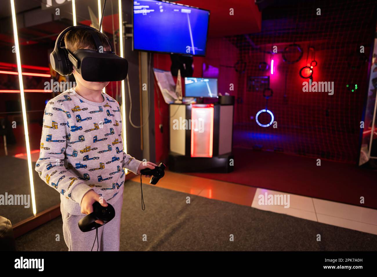 Boy kid playing game using virtual reality headset and gamepads in ...