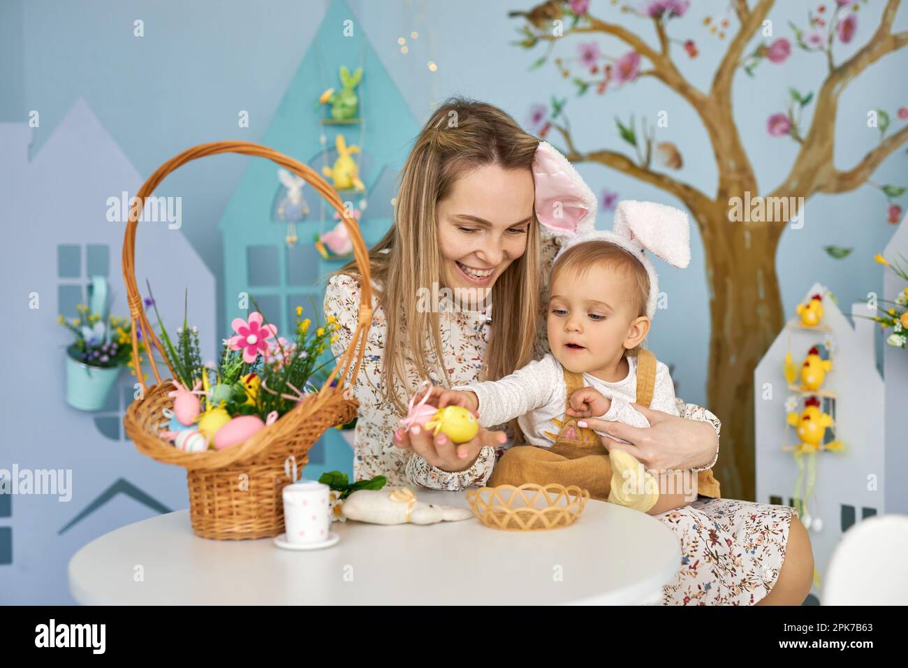 Happy holiday. Mother and her daughter with painting eggs. Family ...