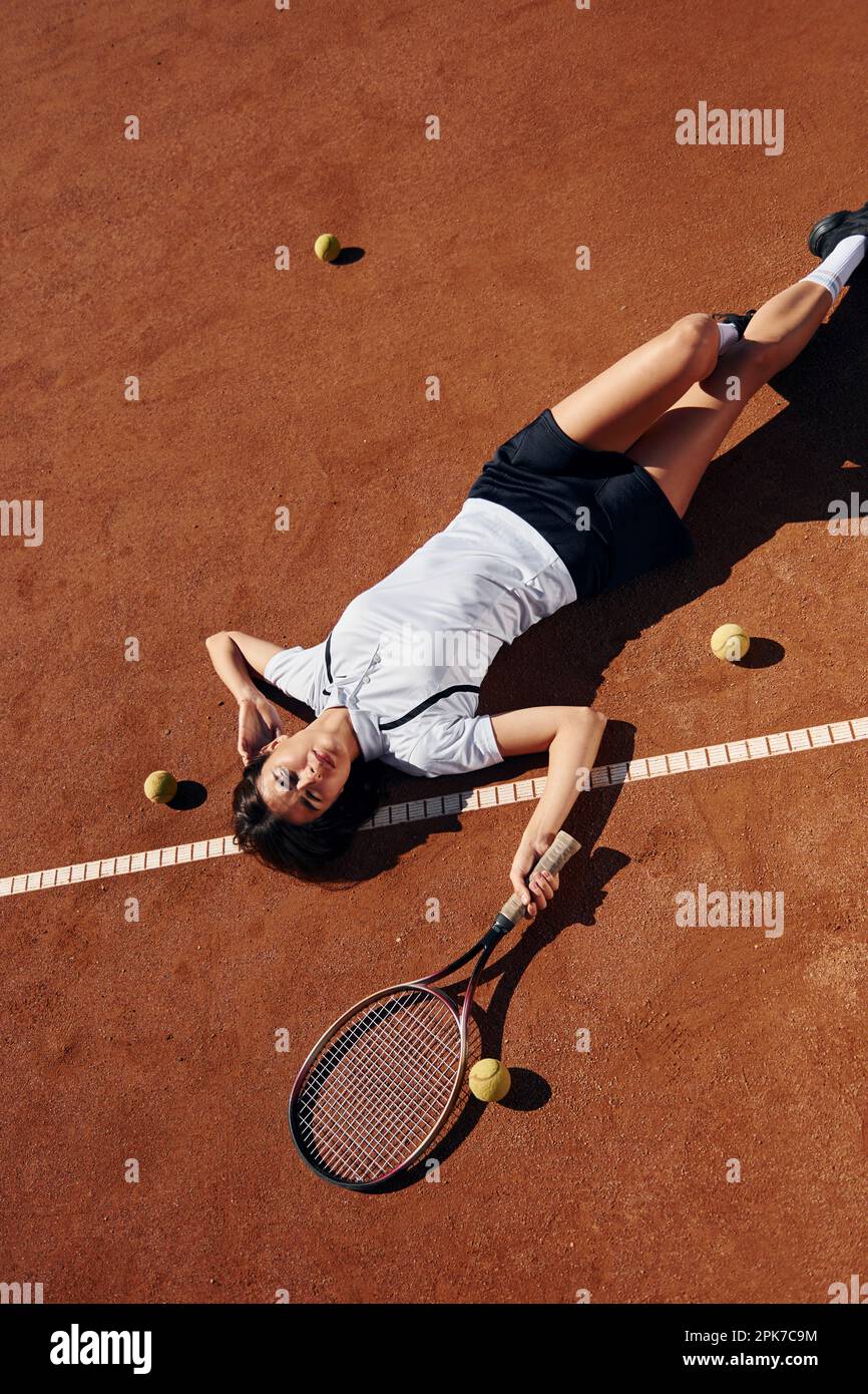 View from above. Female tennis player is on the court at daytime Stock ...