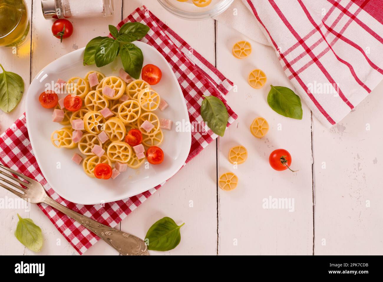 Ruote pasta with tomato and ham Stock Photo - Alamy