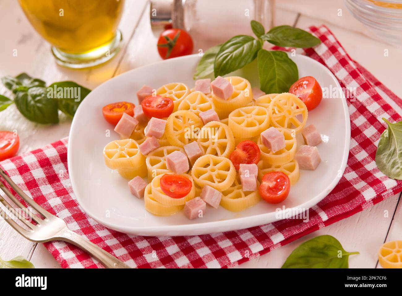 Ruote pasta with tomato and ham Stock Photo - Alamy