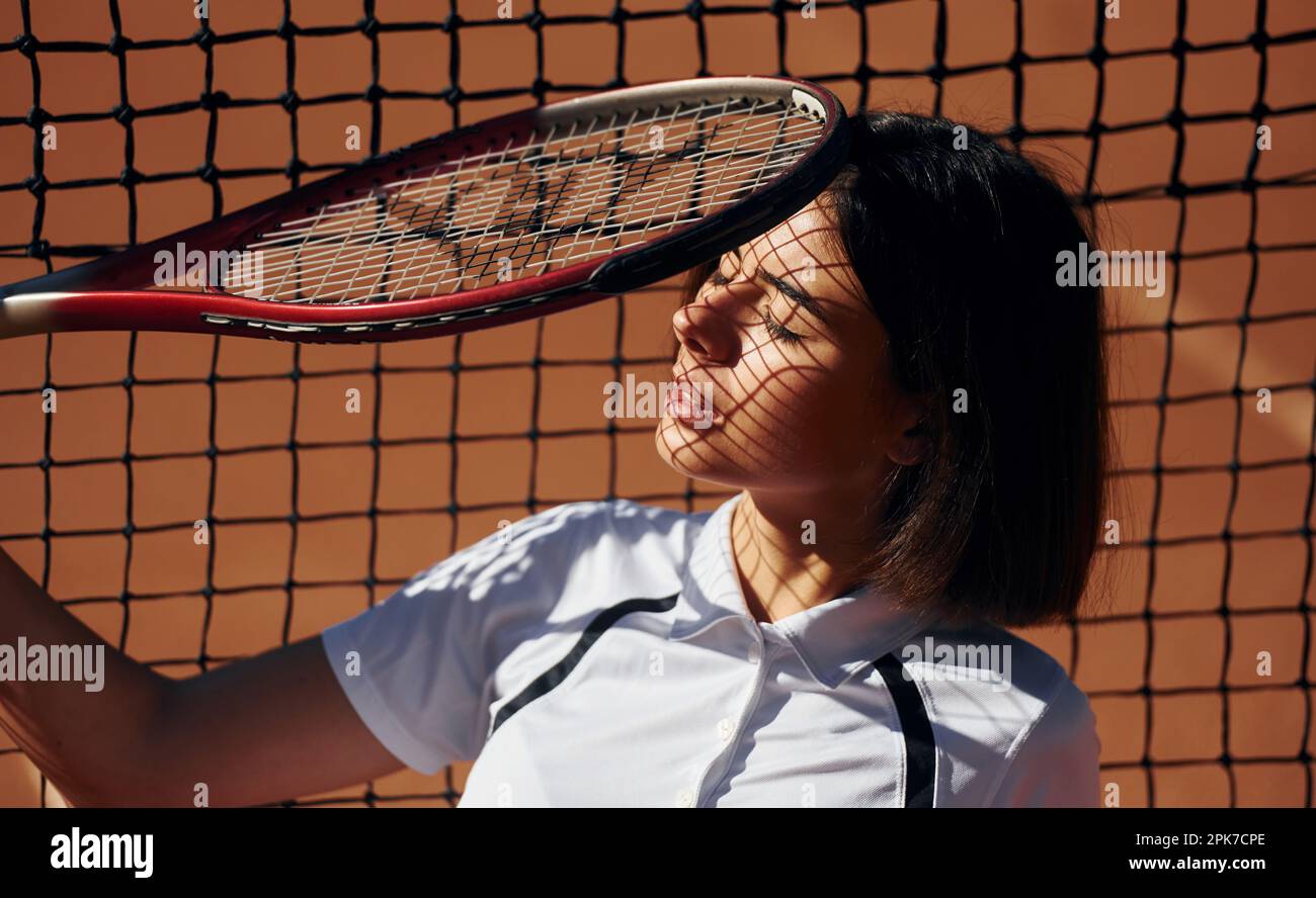 Having a break. Female tennis player is on the court at daytime Stock ...