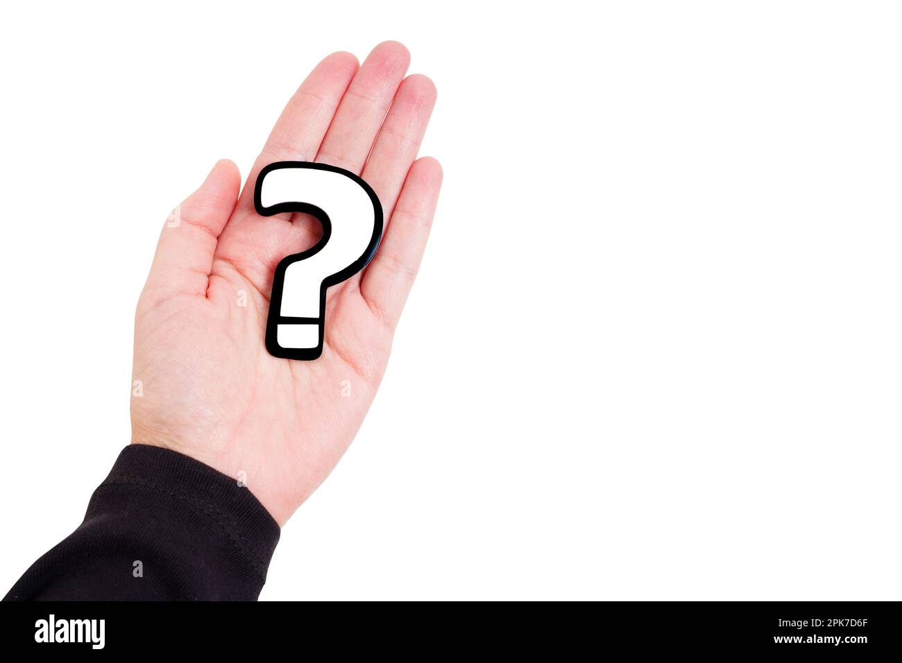 Close-up of a plastic question mark symbol lying on the palm of a hand ...