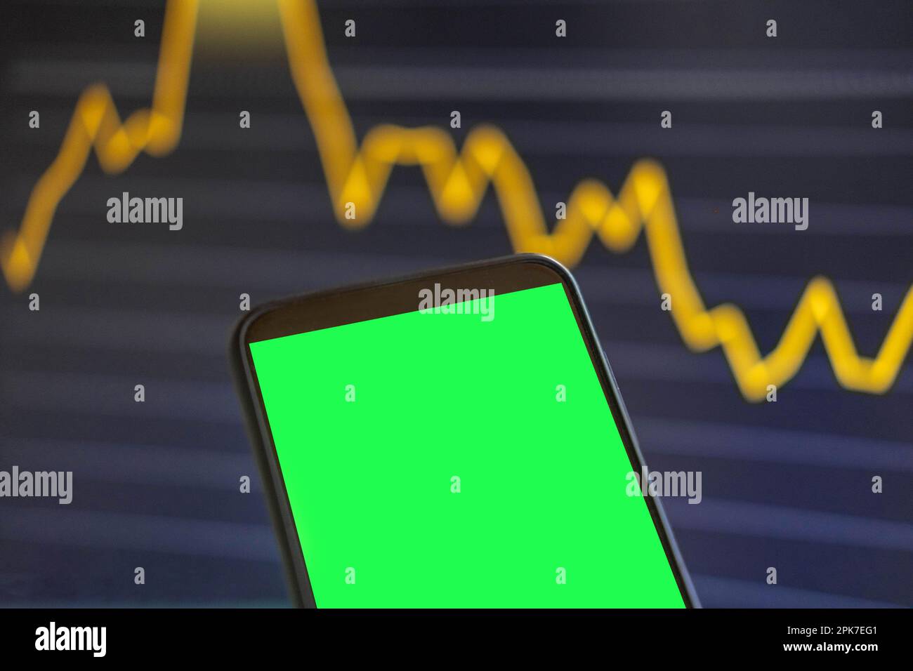 Black phone with blank mockup screen on rising stock graph. Closeup ...