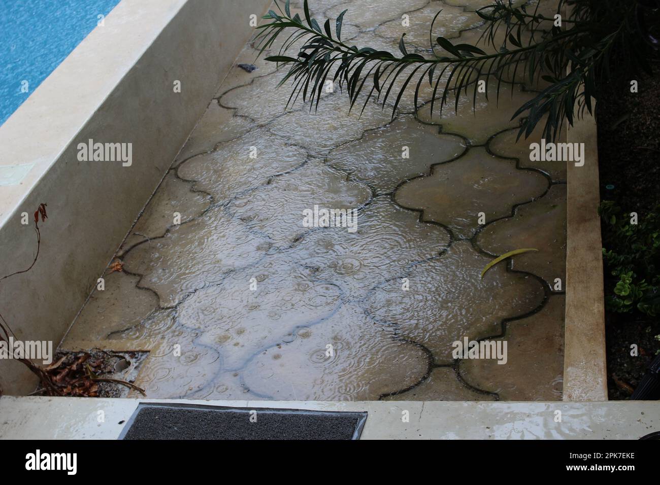 MERIDA, MEXICO - OCTOBER 26, 2016 rain on the path next to the pool ...