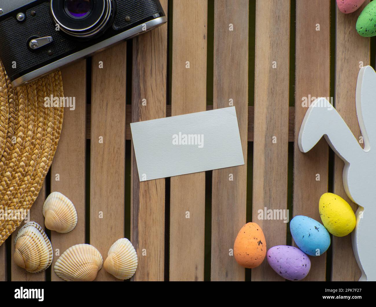 Easter background with straw hat, photo camera, colorful eggs and white ...