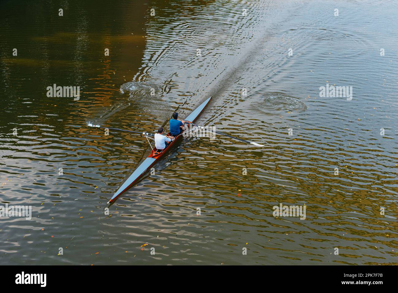 Aerial drone bird's eye view of sport canoe operated by 2 young men in ...