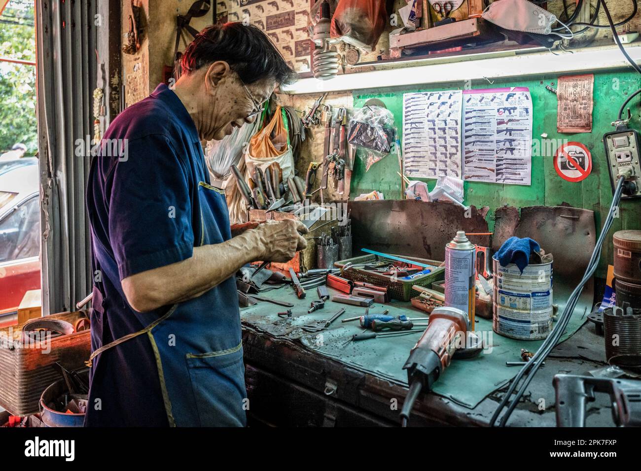 Bangkok, Thailand. 05th Apr, 2023. A local gunsmith, is fixing a part ...