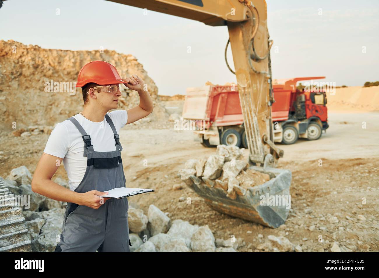 Looking at distant object. Worker in professional uniform is on the ...
