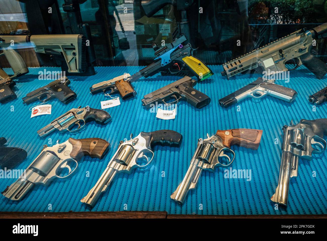 Bangkok, Thailand. 05th Apr, 2023. Firearms seen on display behind the front window of one of ...