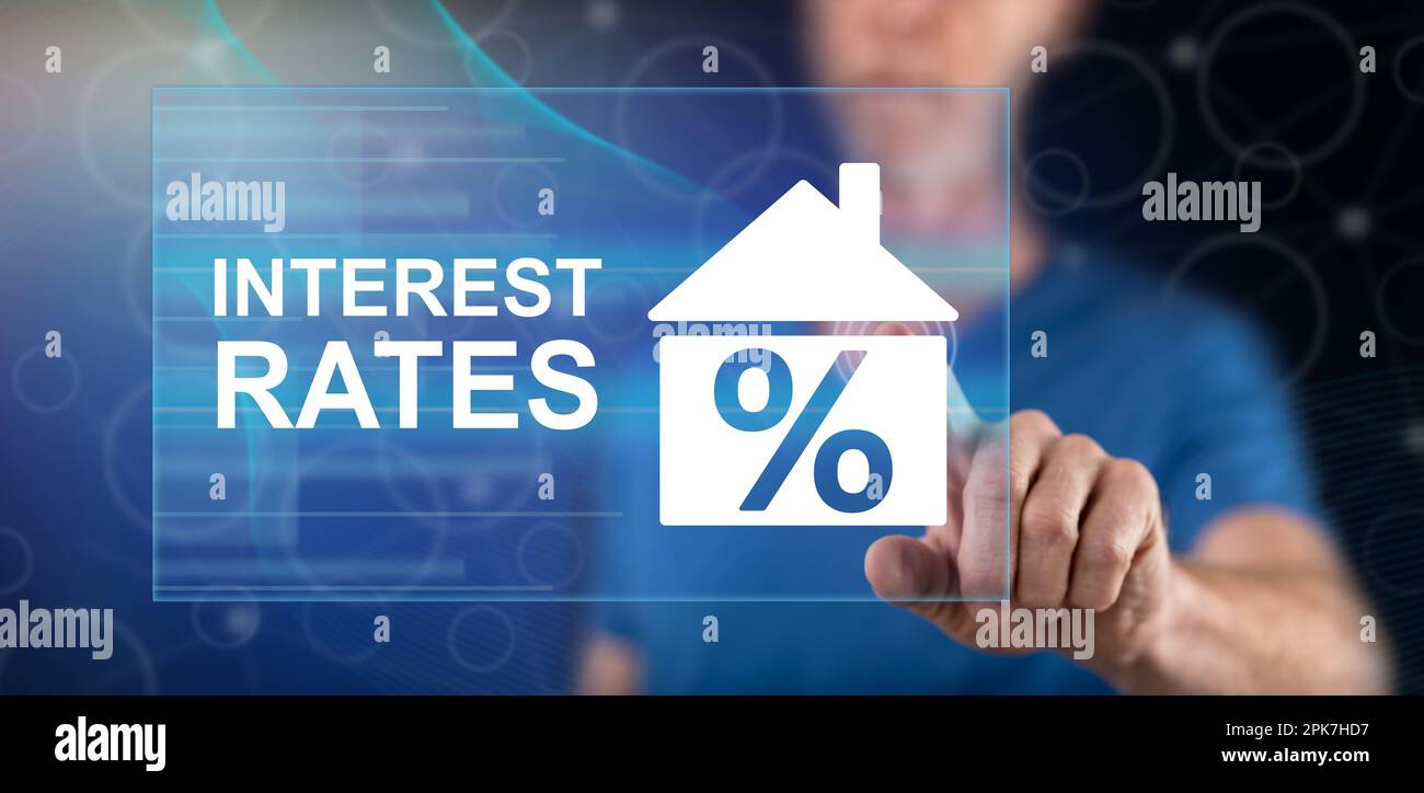 Man touching an interest rates concept on a touch screen with his ...
