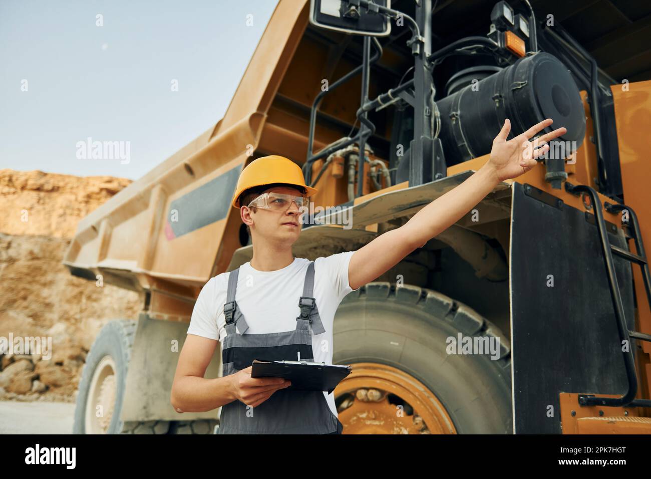 Manager planning the work. Man in professional uniform is on the borrow pit at daytime Stock ...