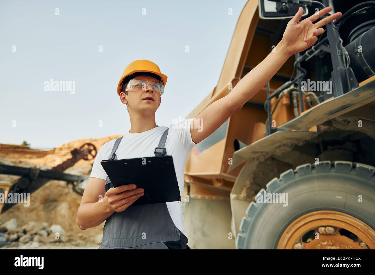 Manager planning the work. Man in professional uniform is on the borrow pit at daytime Stock ...