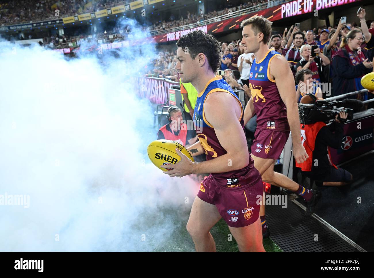 Lachie Neale and Harris Andrews of the Lions lead their team out during ...