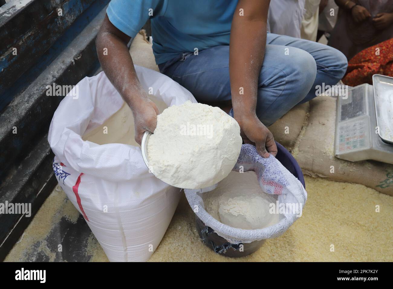 People from low-income groups wait in queues in front of the food ...