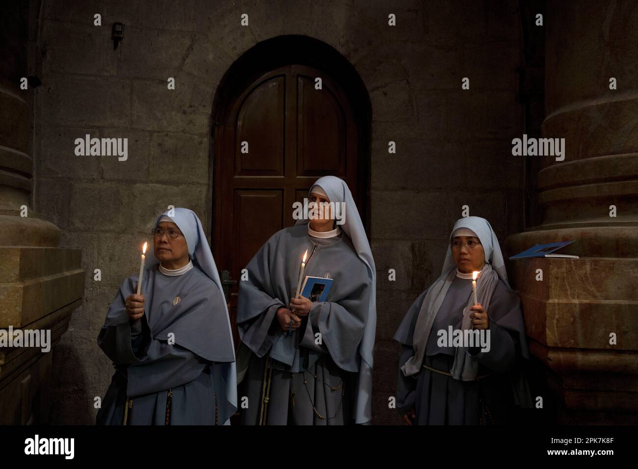 Catholic nuns hold candles during the Holy Thursday procession at the ...