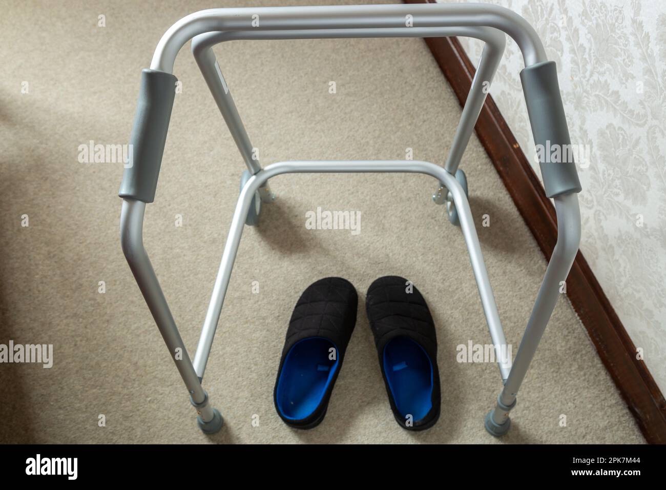Looking down through a zimmer frame at a pair of mens slippers Stock ...
