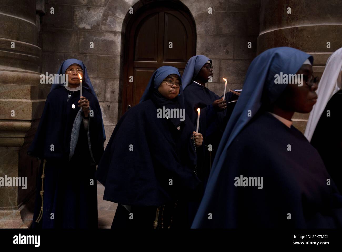 Catholic nuns hold candles during the Holy Thursday procession at the ...