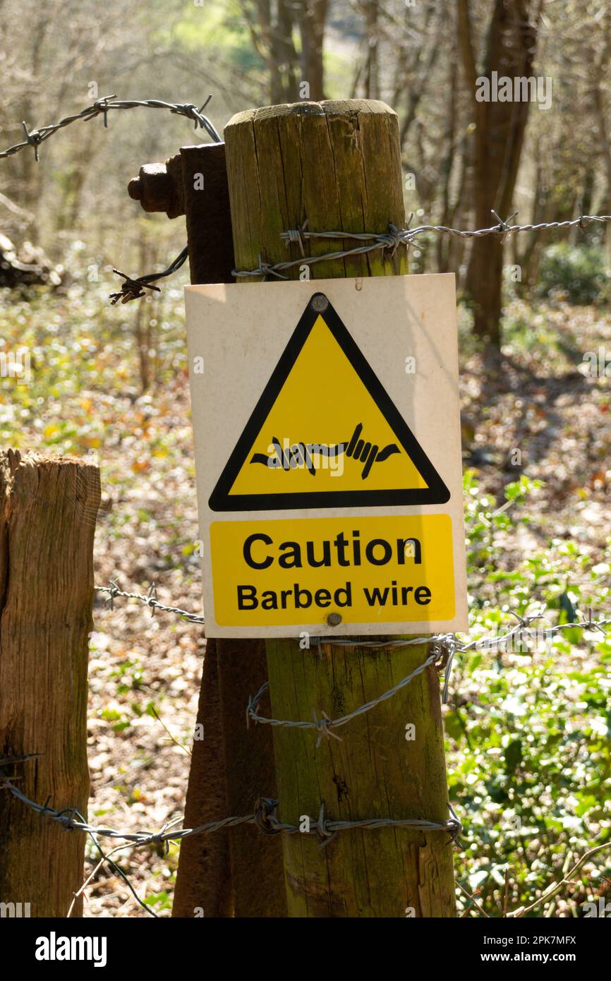 Caution Barbed Wire sign, UK Stock Photo - Alamy