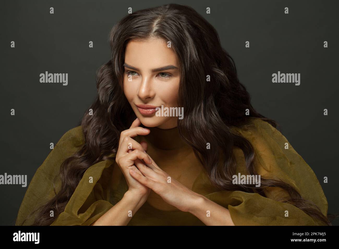 Cute brunette model woman with long perfect hair against black studio ...