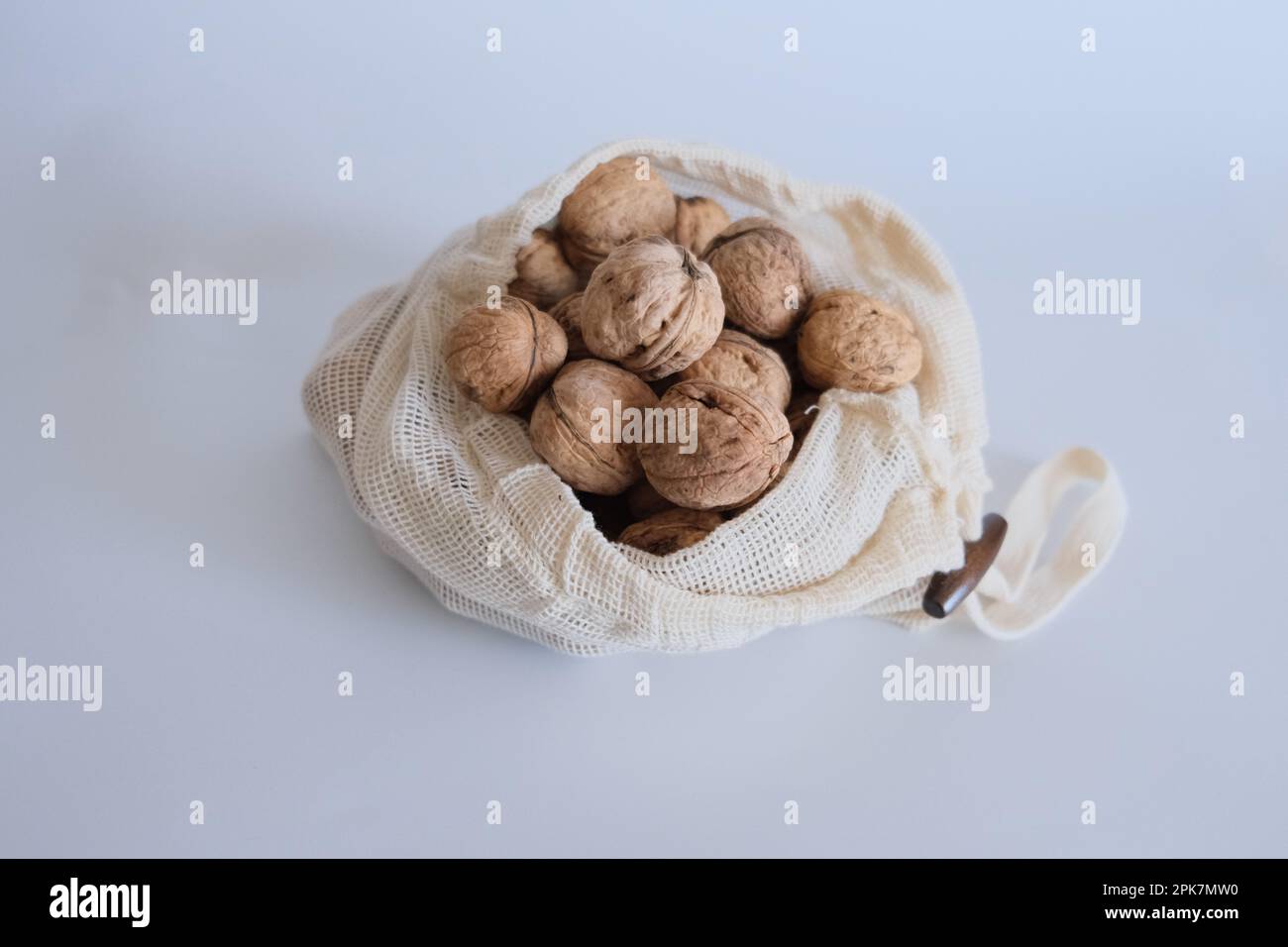 Shelled walnuts, pile of walnuts with shelled in three white cloth bags ...