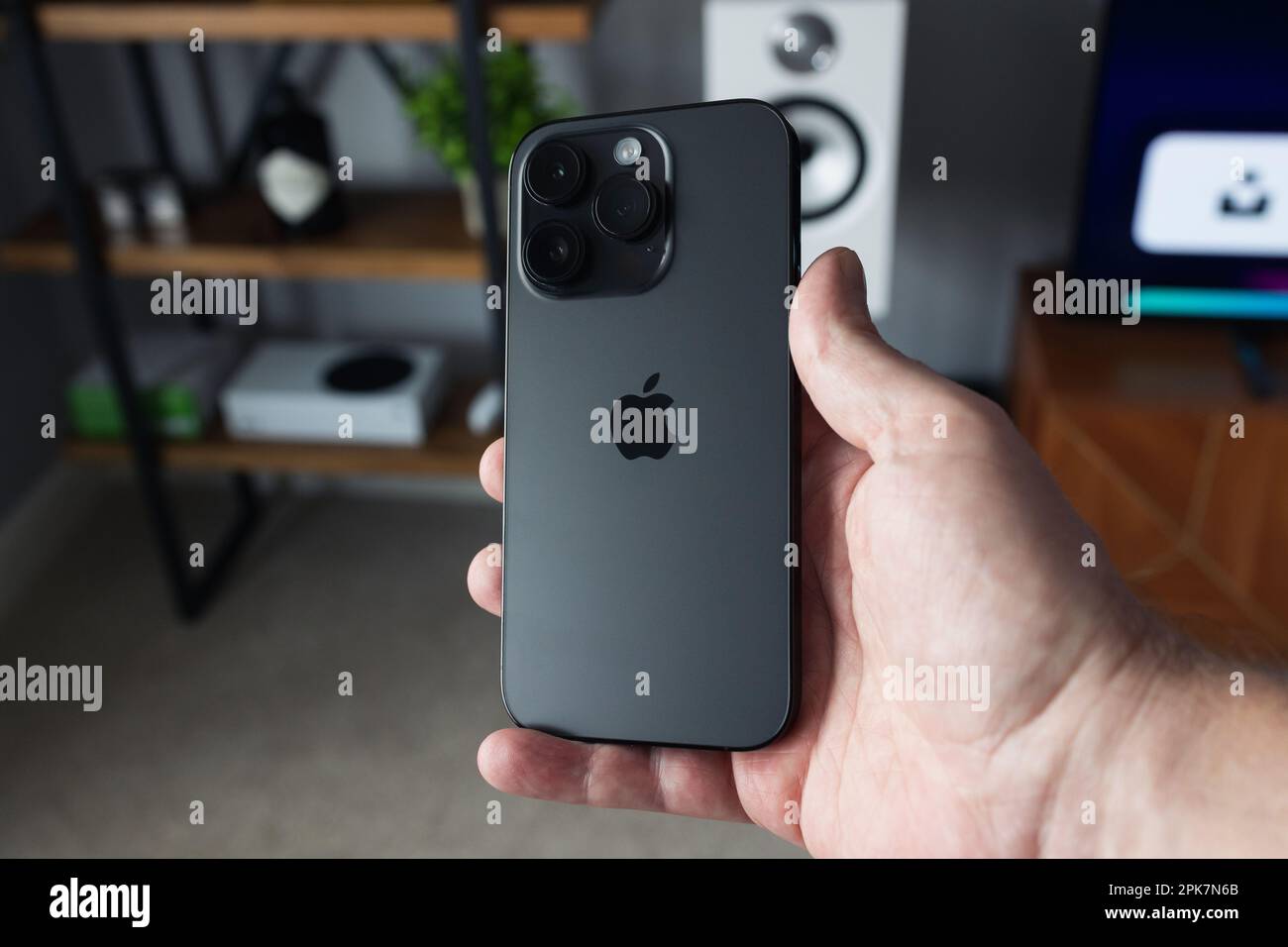 LONDON - MARCH 30, 2023: Man holding Space Grey Black Apple iPhone 14 ...