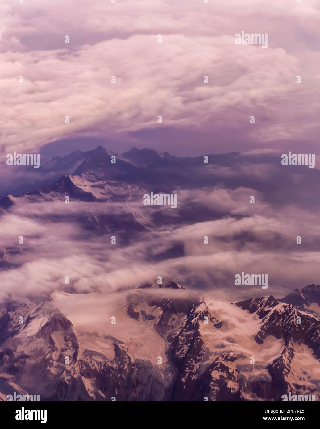 Aerial view of a thin layer of monsoon clouds over the snow covered ...