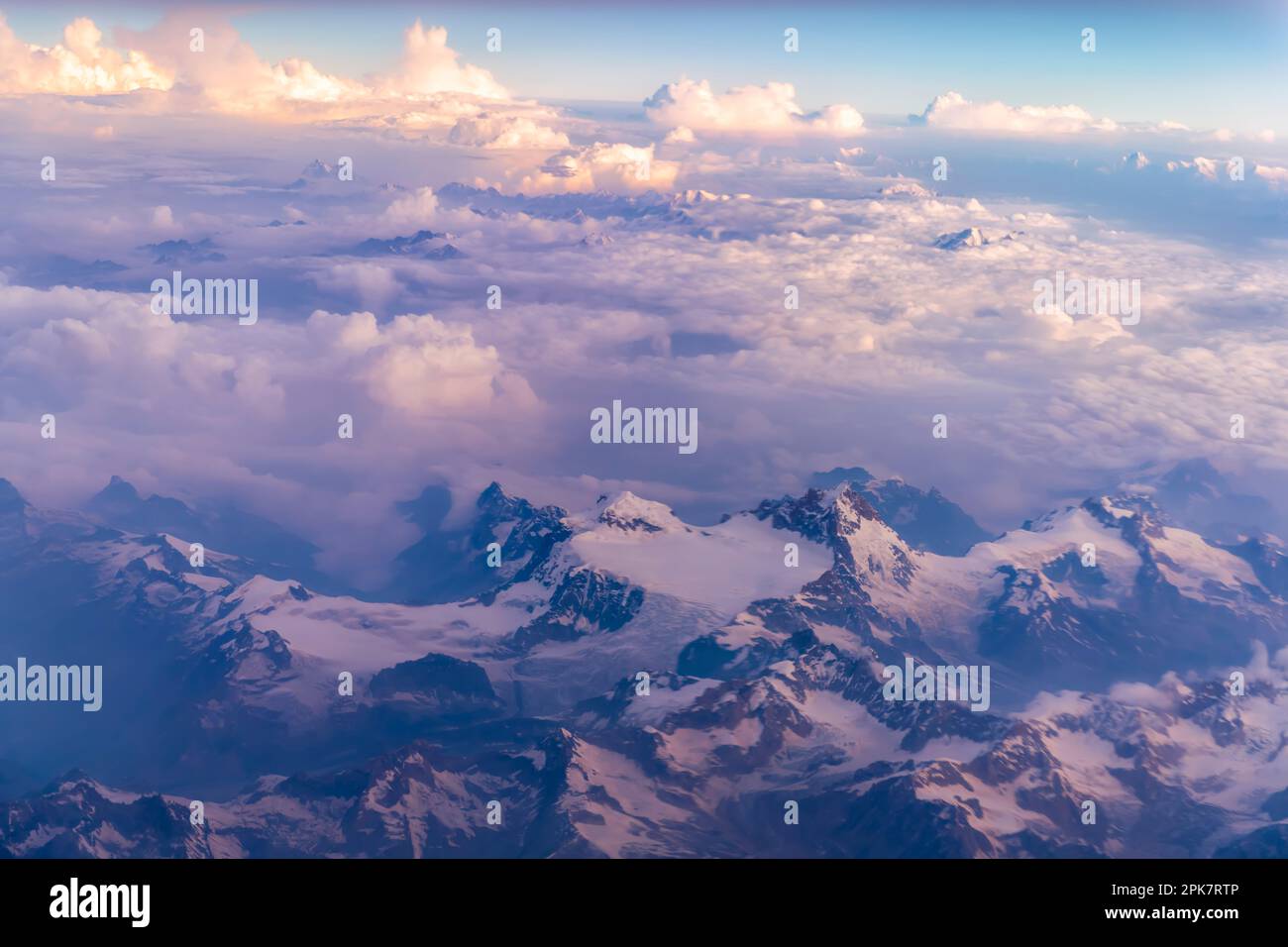 Aerial view of a thin layer of monsoon clouds over the snow covered ...