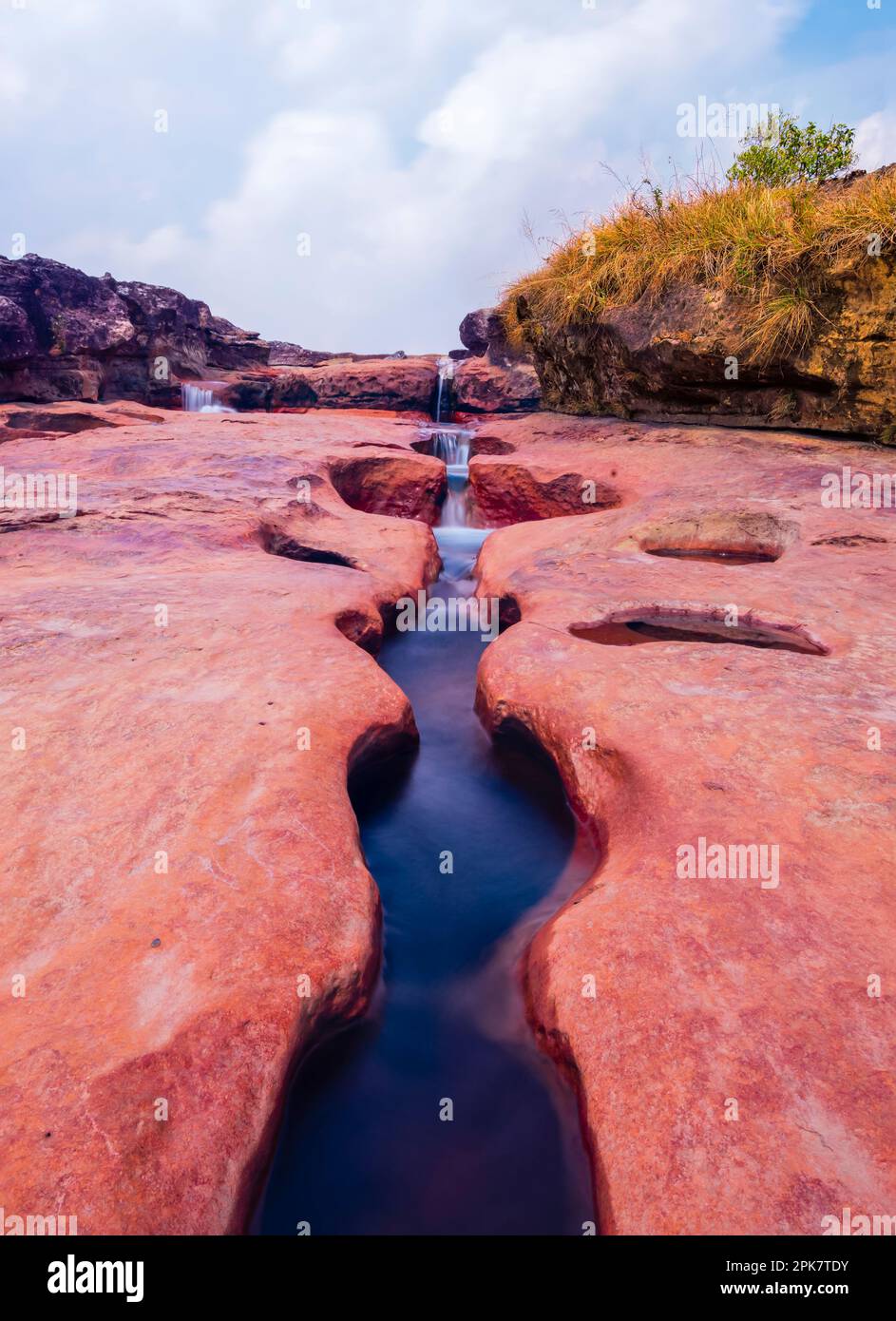 A stream carving out a path through thick rock. Photograph taken in ...
