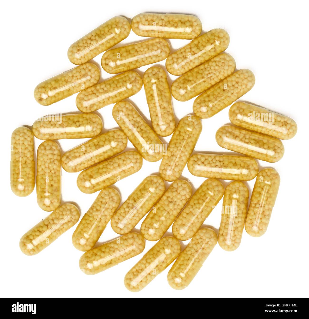 Transparent medical capsules with yellow granules inside on a white ...