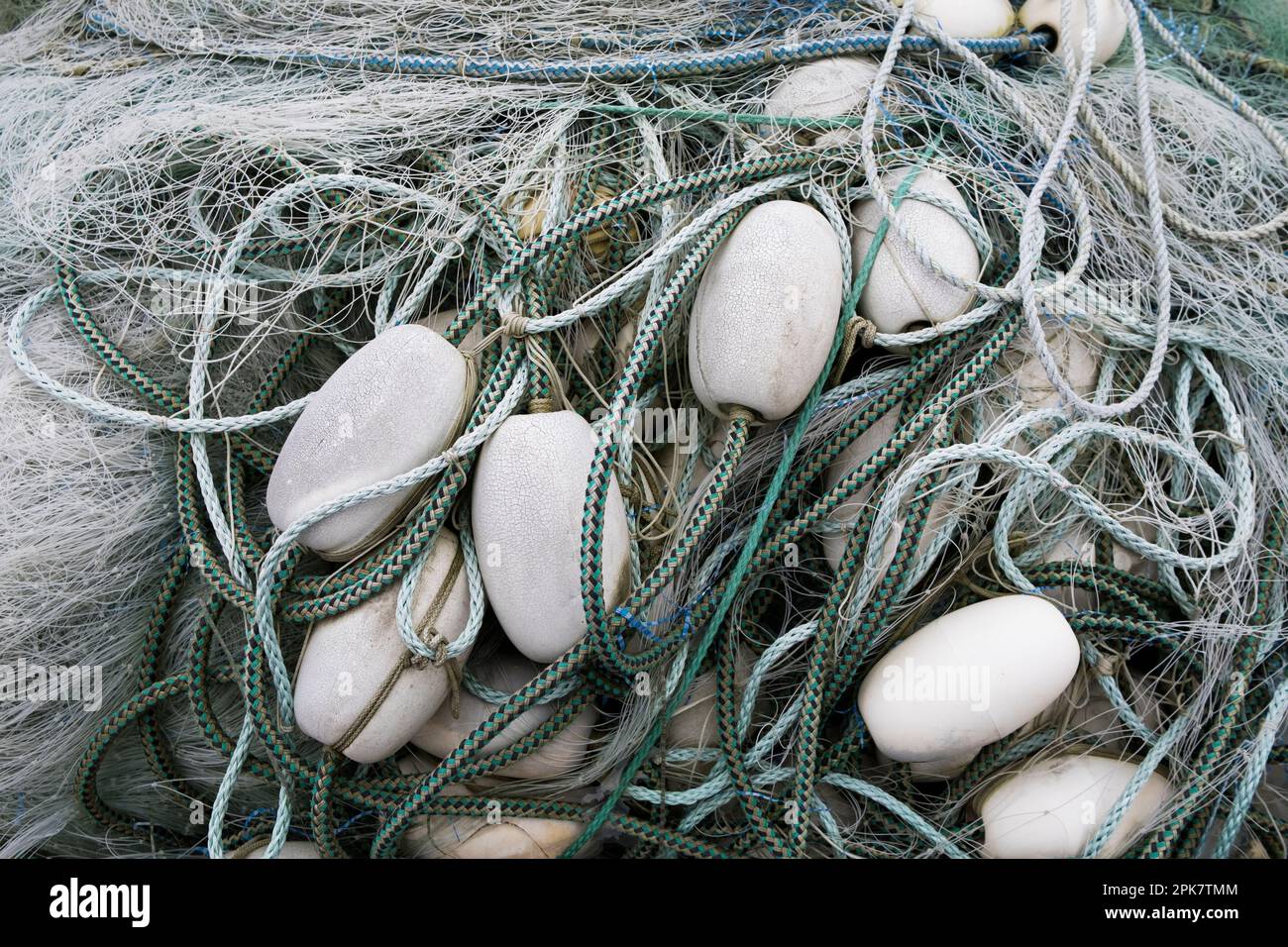 A pile of commercial fishing nets with ropes and plastic floats Stock ...