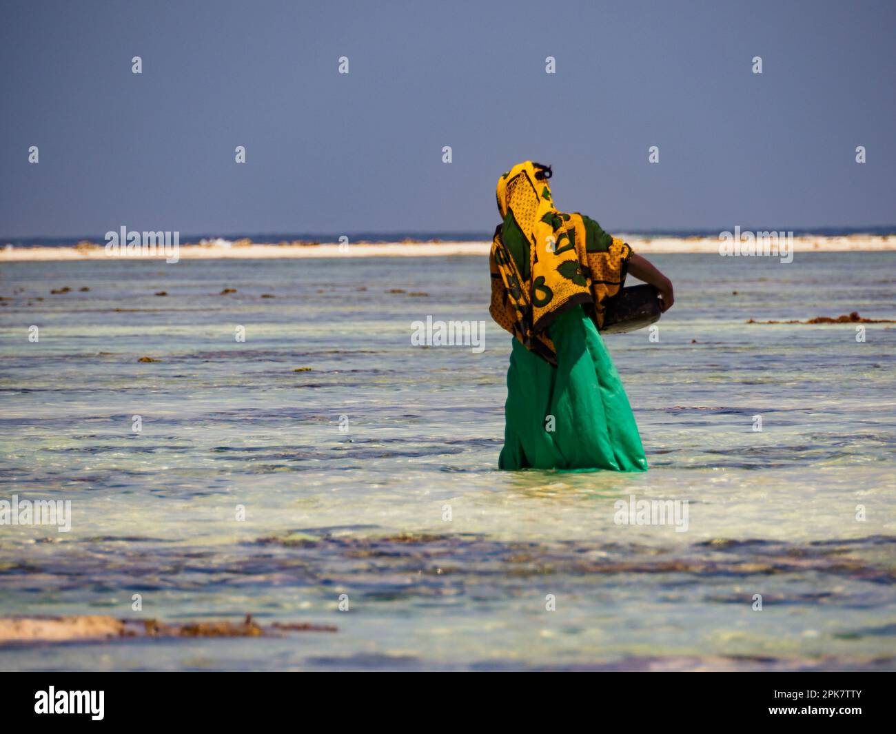 Matemwe, Zanzibar - January 2021: Woman in green dress and yellow ...