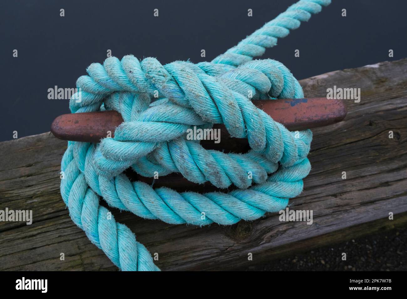 Industrial rope tied around a metal boat cleat Stock Photo - Alamy